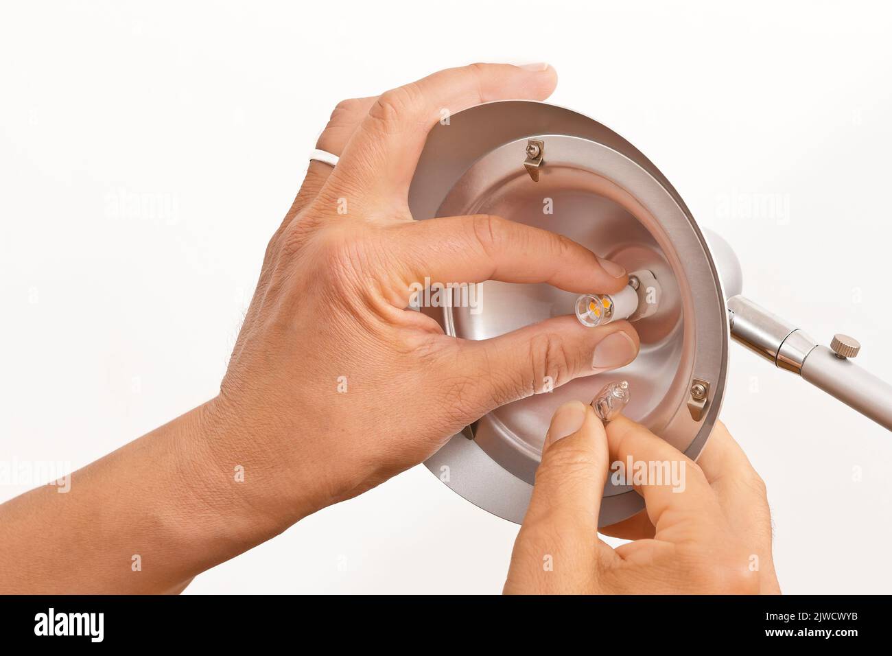 Saving electricity concept: closeup of male hands exchanging an old ...