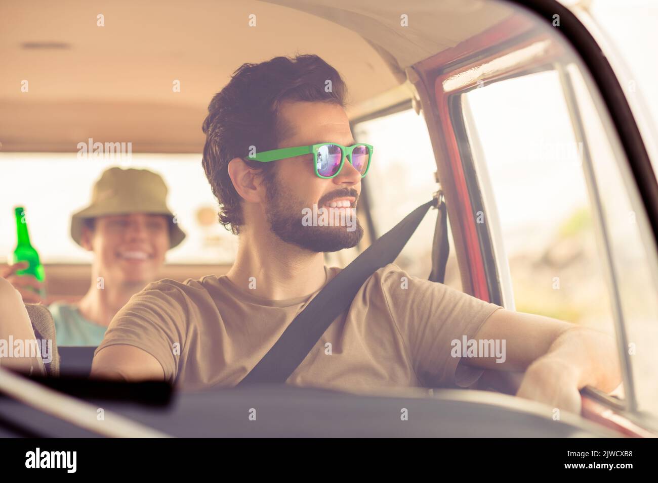 Photo of two cheerful positive guys sitting drive van have good mood ...