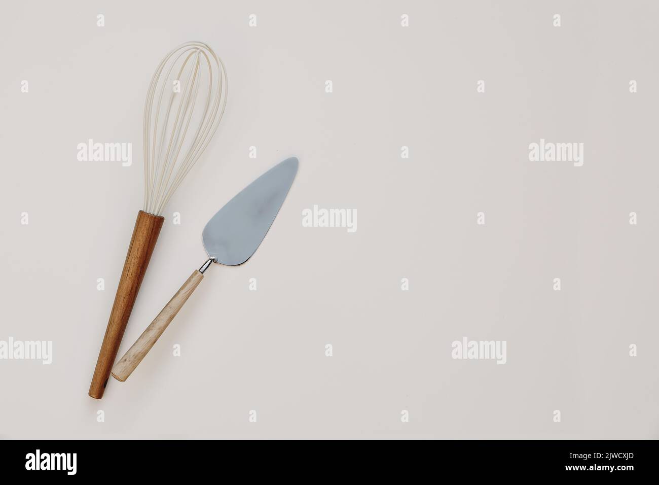Elegant kitchen utensils, kitchenware. White silicon whisk and cake ...