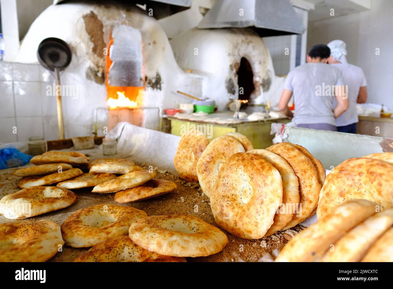 Tashkent Uzbekistan - bakers making fresh round local bread at a bakery ...