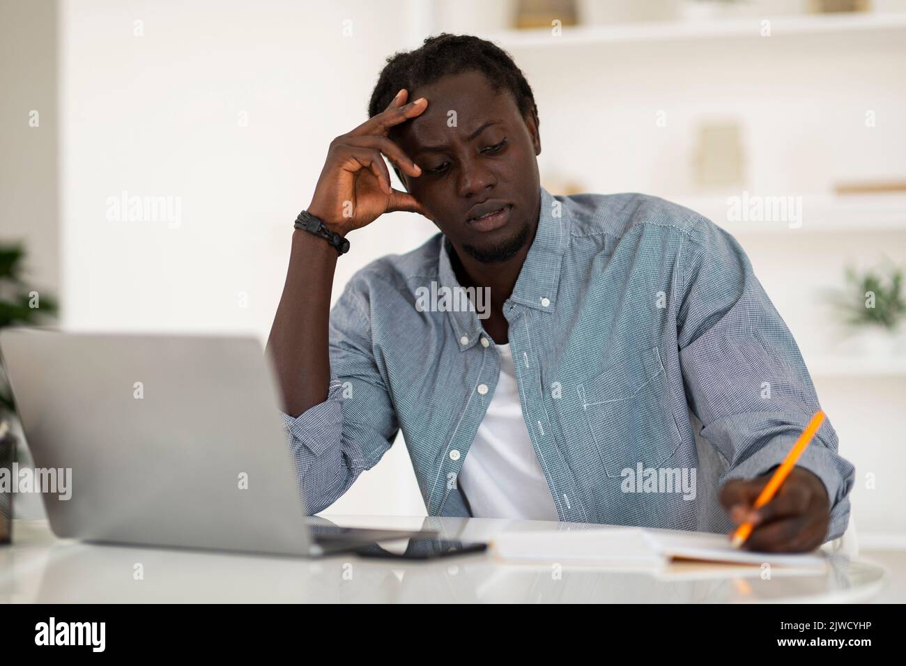 Young black man taking notes hi-res stock photography and images - Alamy