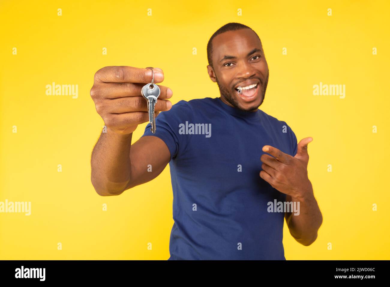 Cheerful Black Man Holding New House Keys Over Yellow Background Stock ...