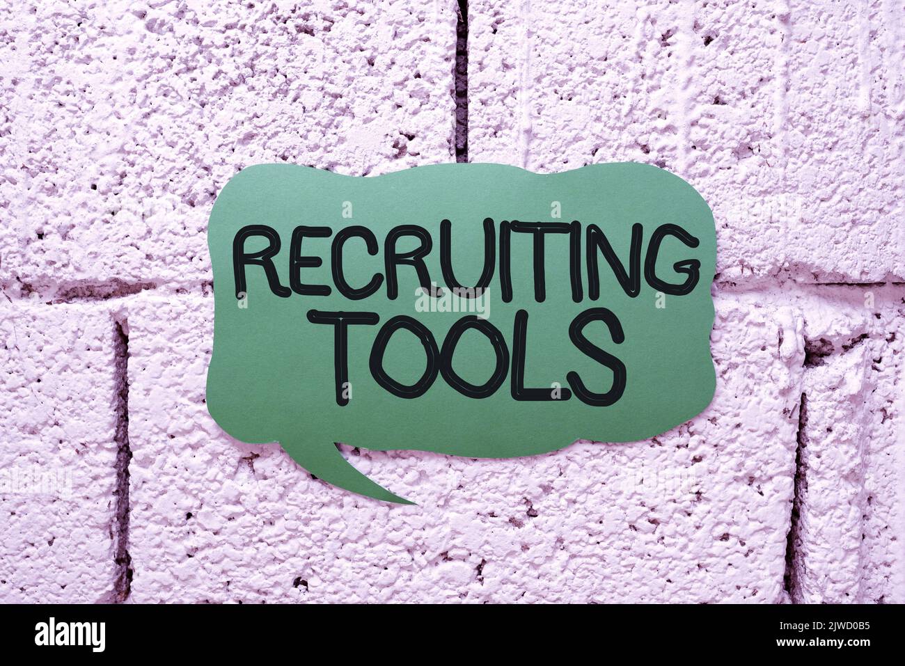 Hand writing sign Recruiting Toolsgetting new talents to your company ...