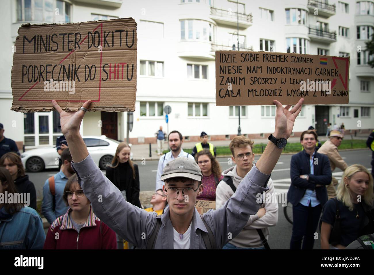 A student holds signs during a protest against a newly introduced ...