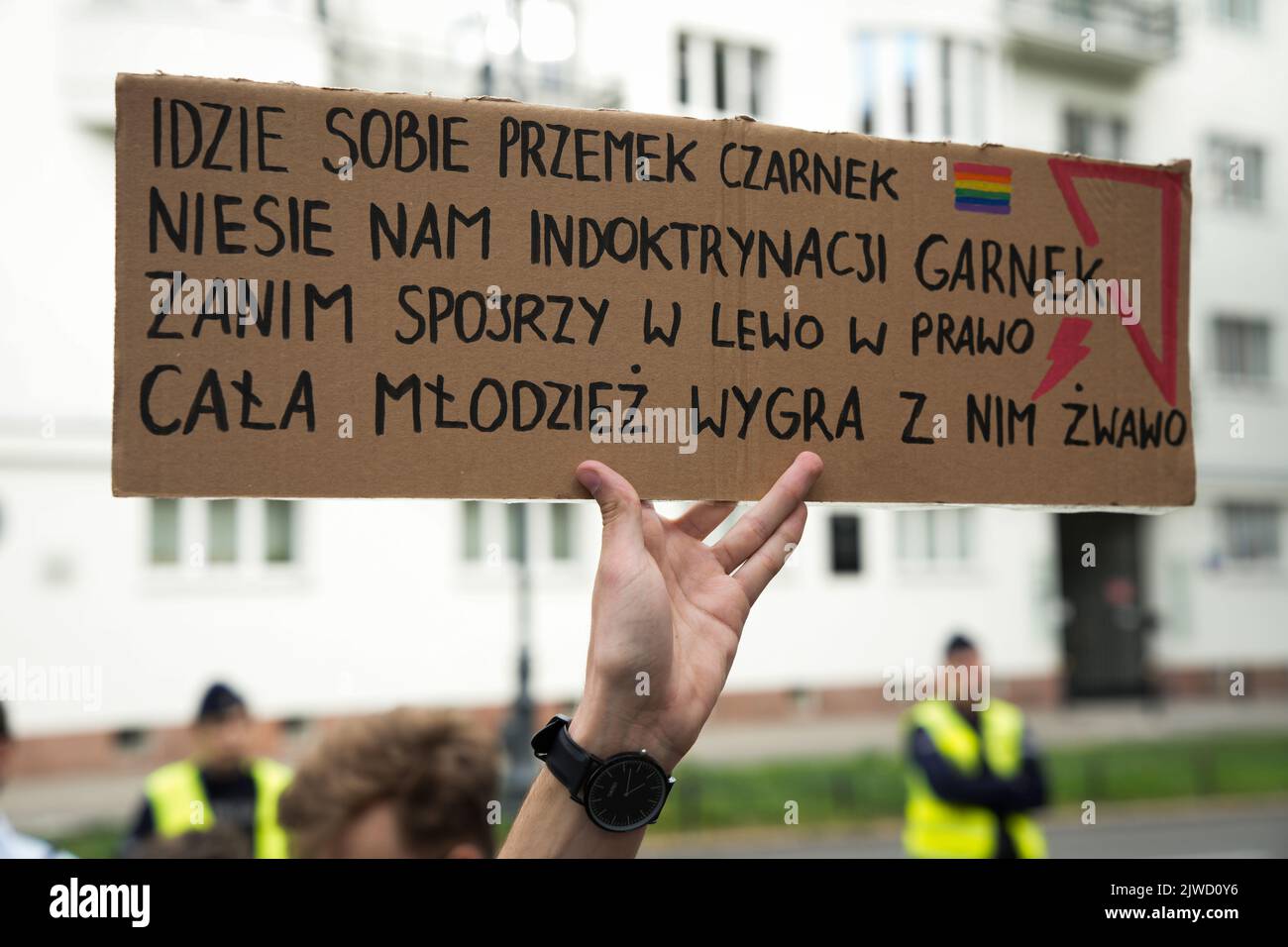 A student holds signs during a protest against a newly introduced ...