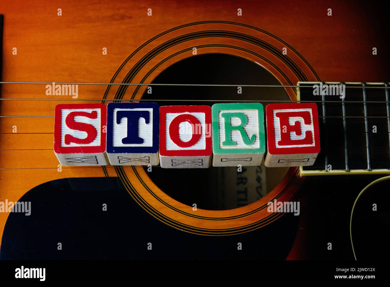 Word or phrase Store made with the letter cubes, standing on a guitar ...