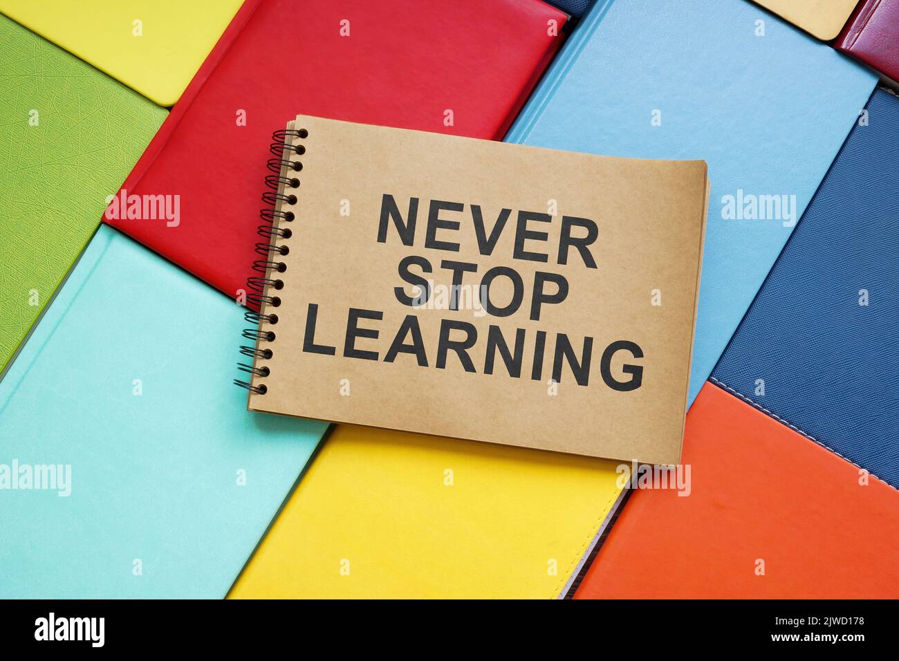 Never stop learning sign on the colorful books Stock Photo - Alamy