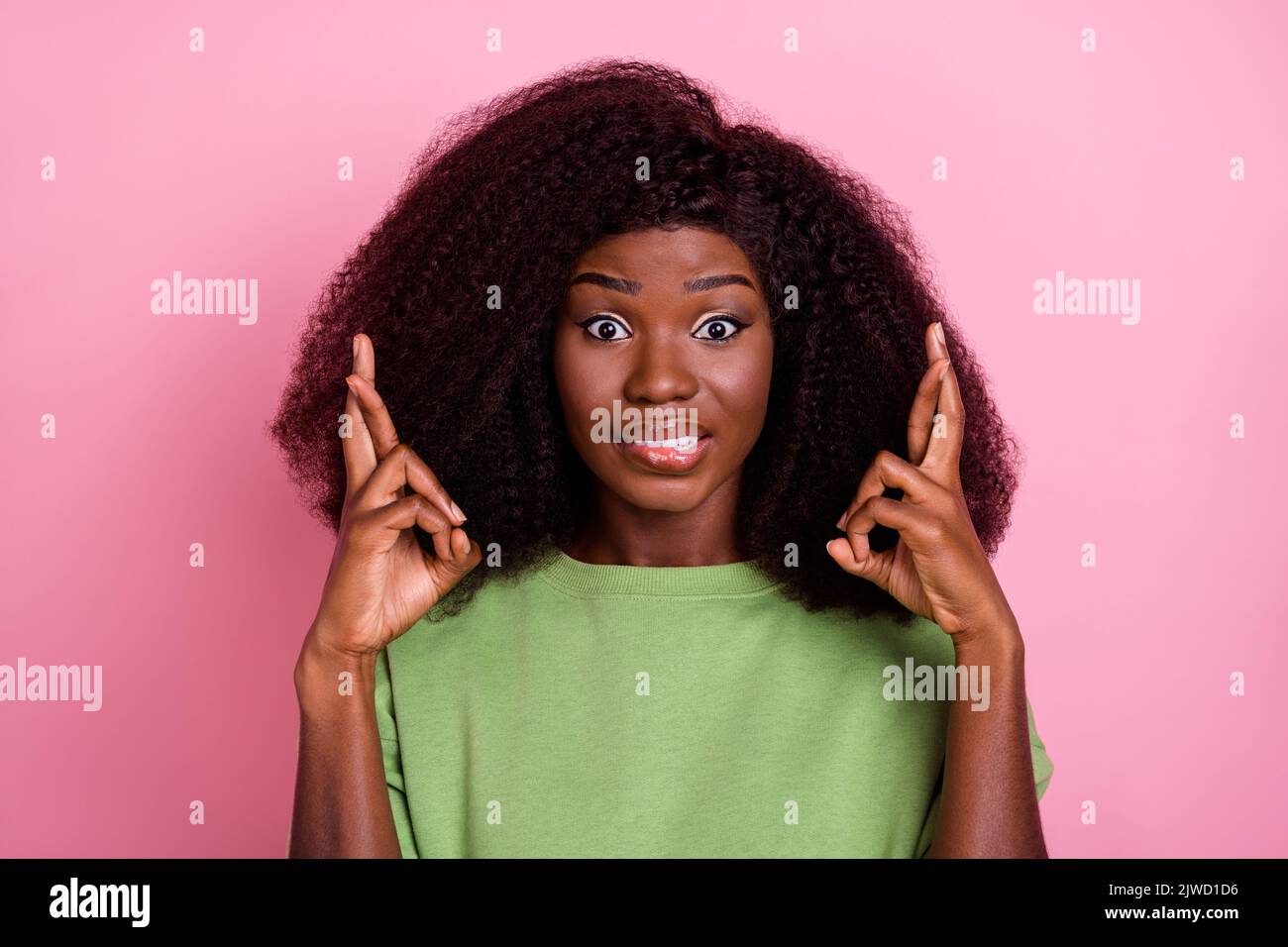 Photo of nervous curly hairdo brunette lady cross fingers wear green ...