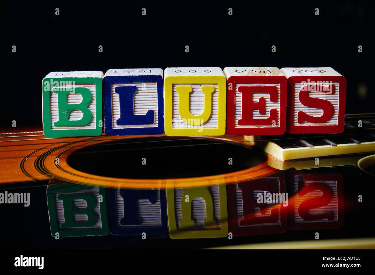 Word or phrase Blues made with the letter cubes, standing on a guitar ...
