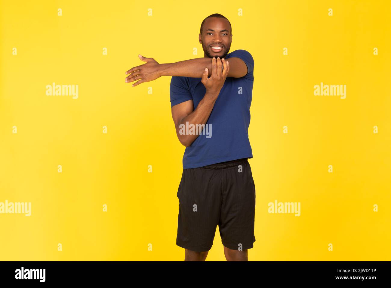 Athletic Black Guy Exercising Stretching Arms Having Workout, Yellow ...