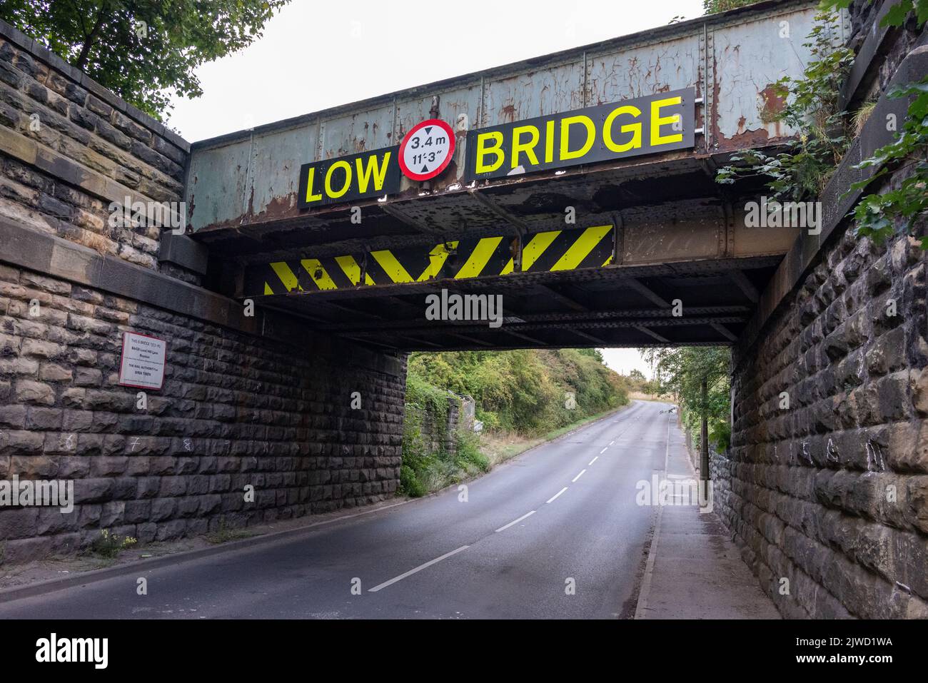 Low bridge warning sign on a railway bridge, UK Stock Photo - Alamy