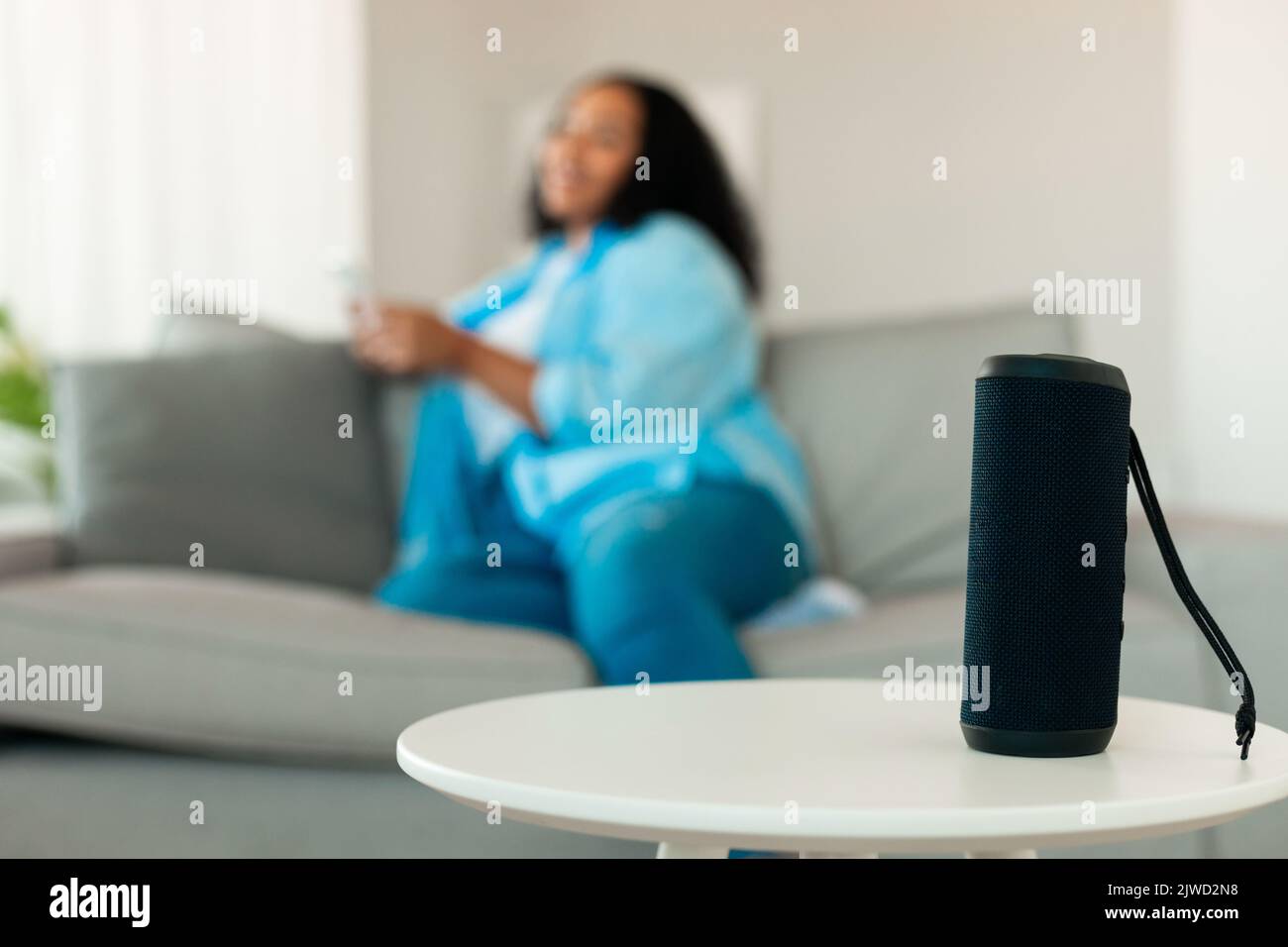 Musical Column Standing On Table While Lady Listening Music Indoors ...