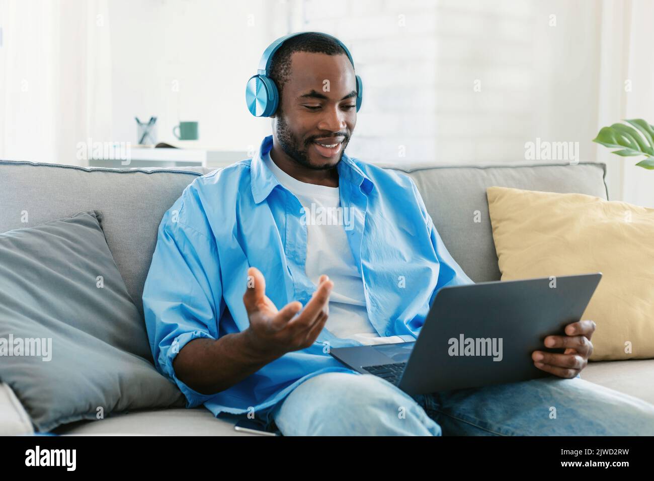 Freelancer african american man video calling via laptop, wearing ...