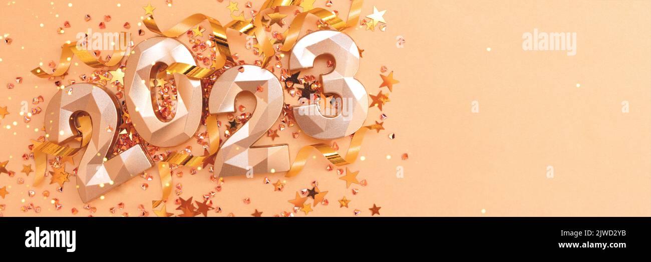 Banner with 2023 gold colored numbers, ribbons and stars confetti ...