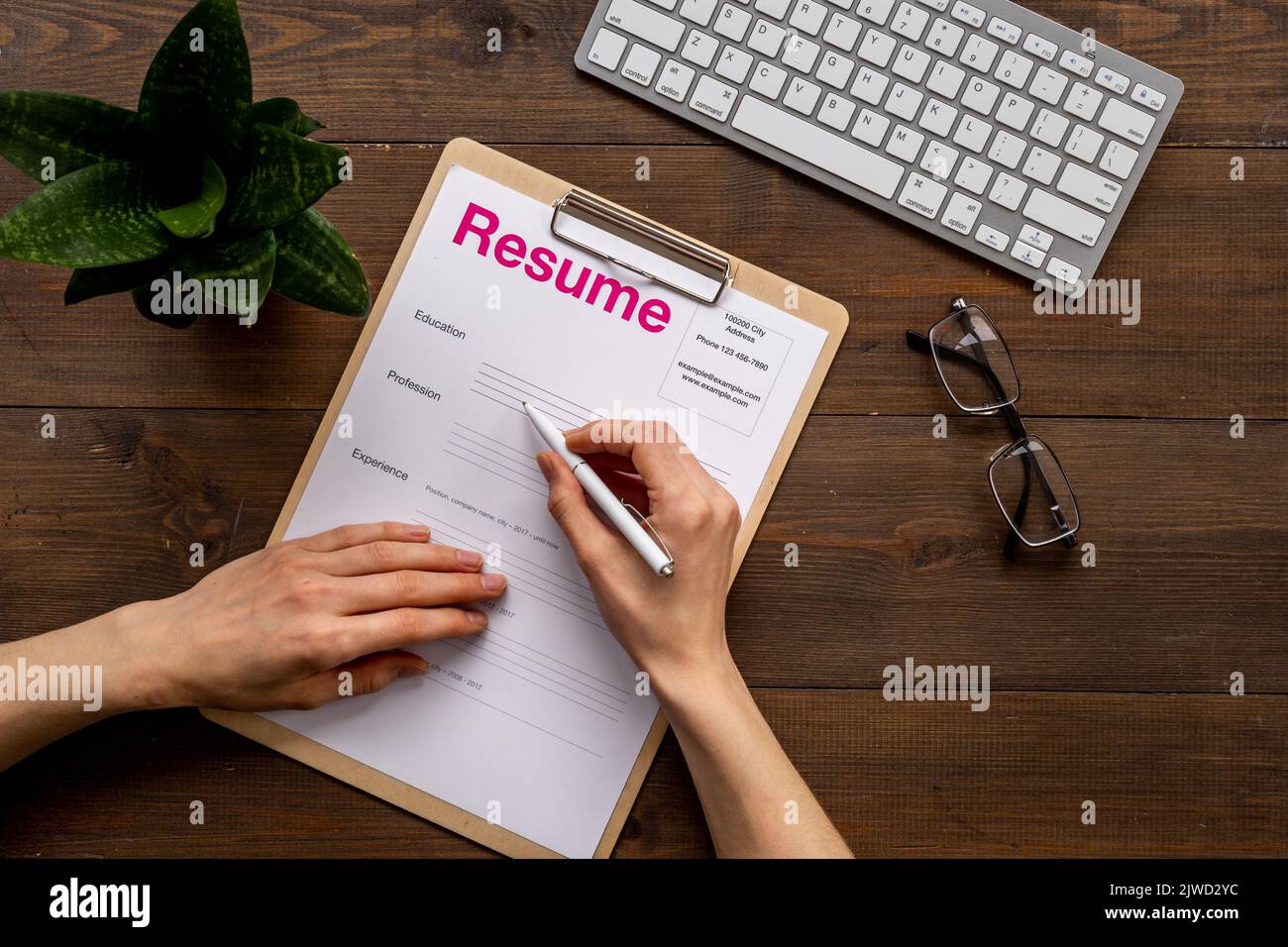 Job seeker filling resume application form on office table Stock Photo ...