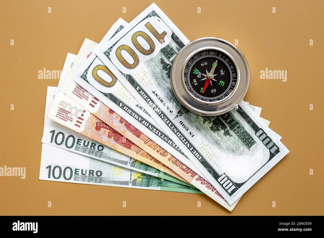 Compass and money cash. Exchange quotes of currencies concept Stock ...