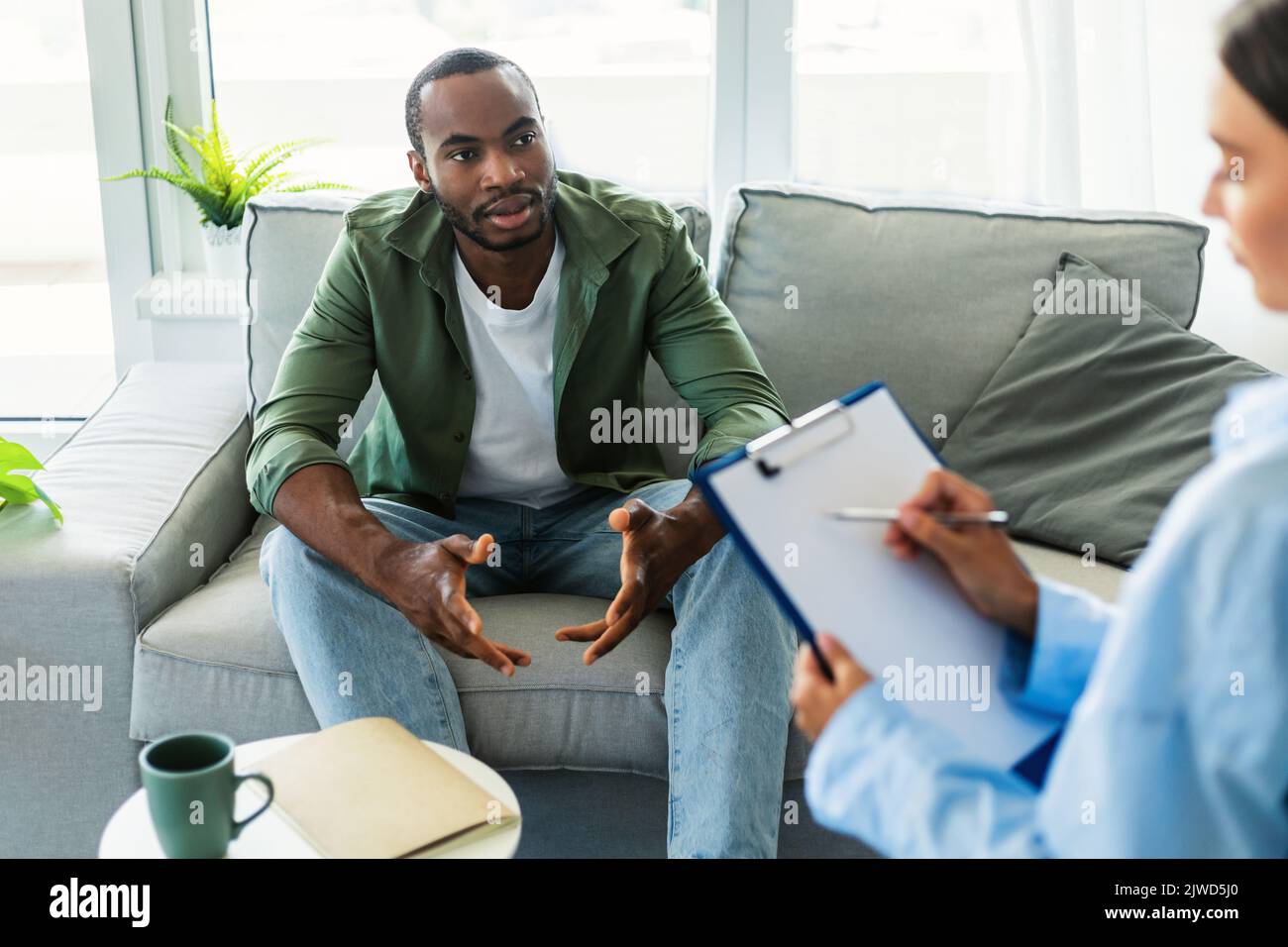 Black man suffering from depression, counselor providing professional ...
