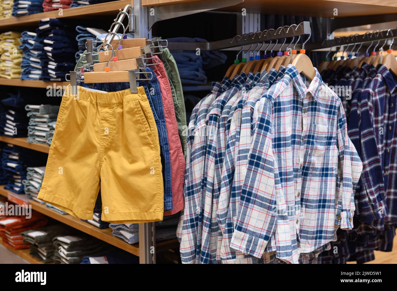 New arrival shirt and trousers hanging in clothes shop Stock Photo - Alamy