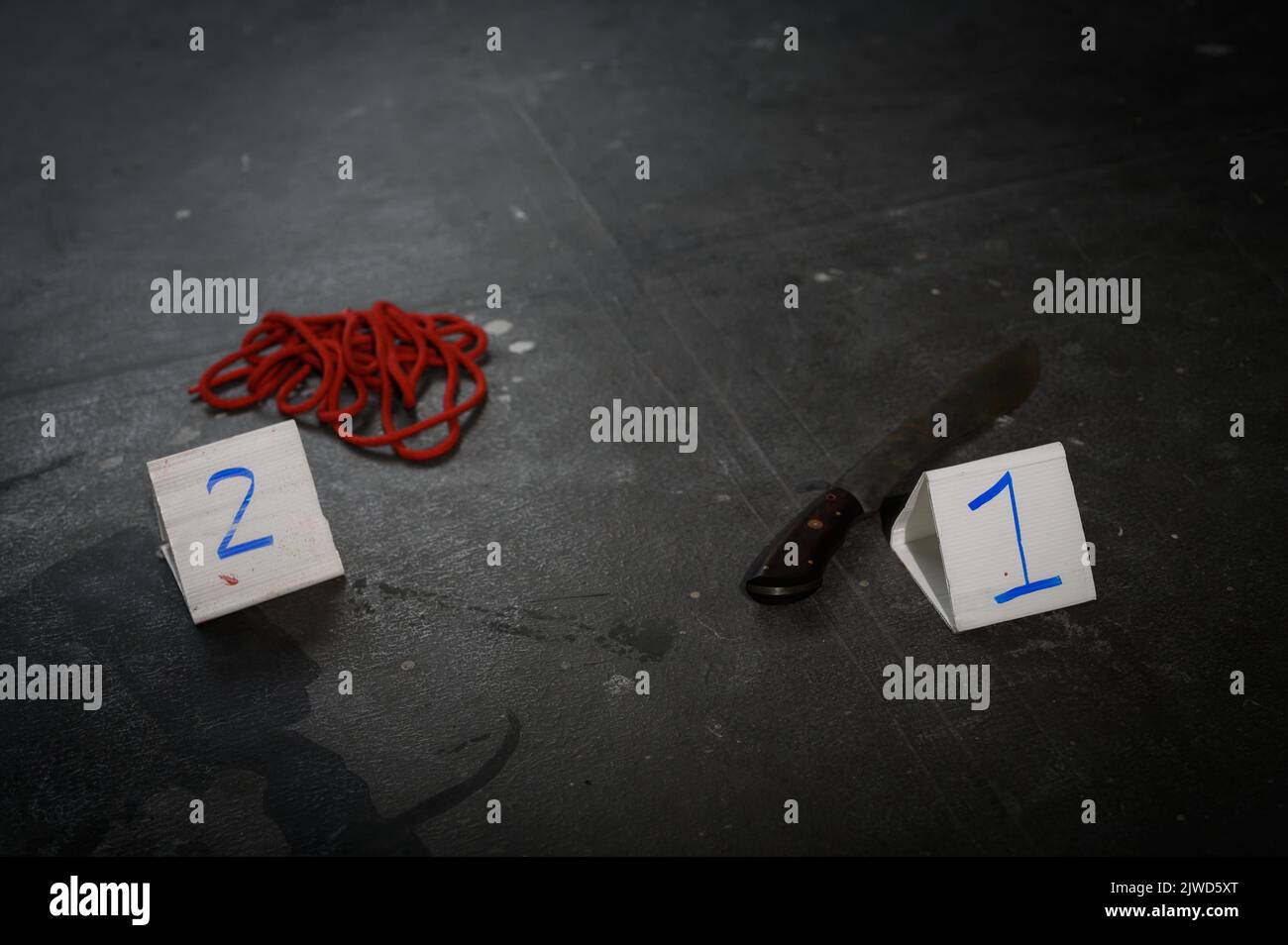 Evidence and crime scene markers on black background Stock Photo - Alamy