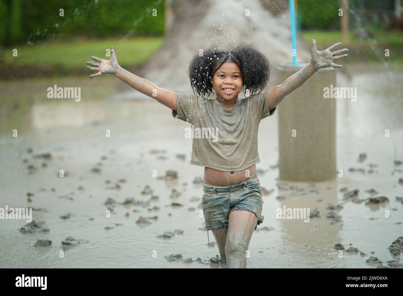 Group of kids playing on muck in the raining day Stock Photo - Alamy