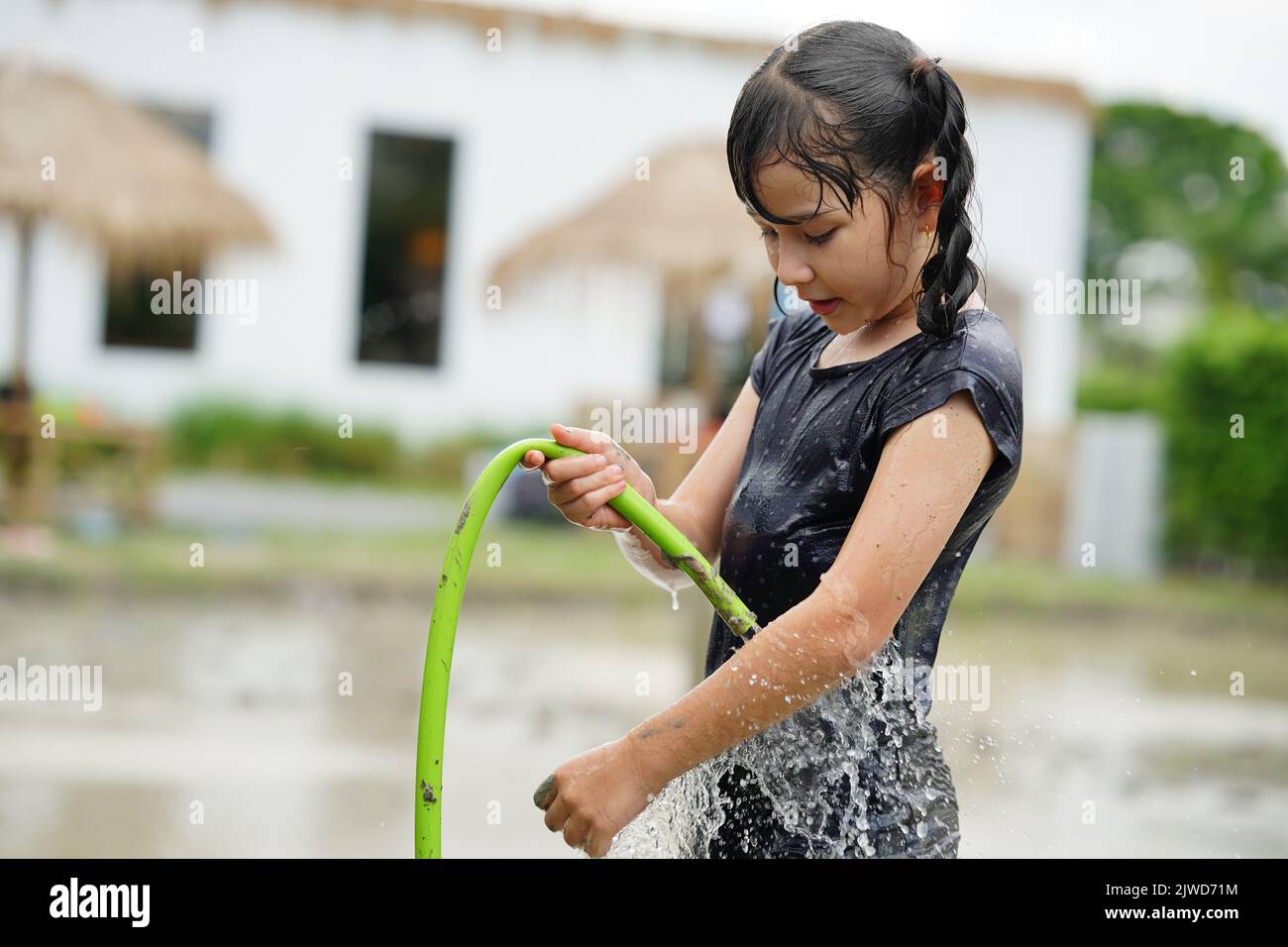 Group of kids playing on muck in the raining day Stock Photo - Alamy