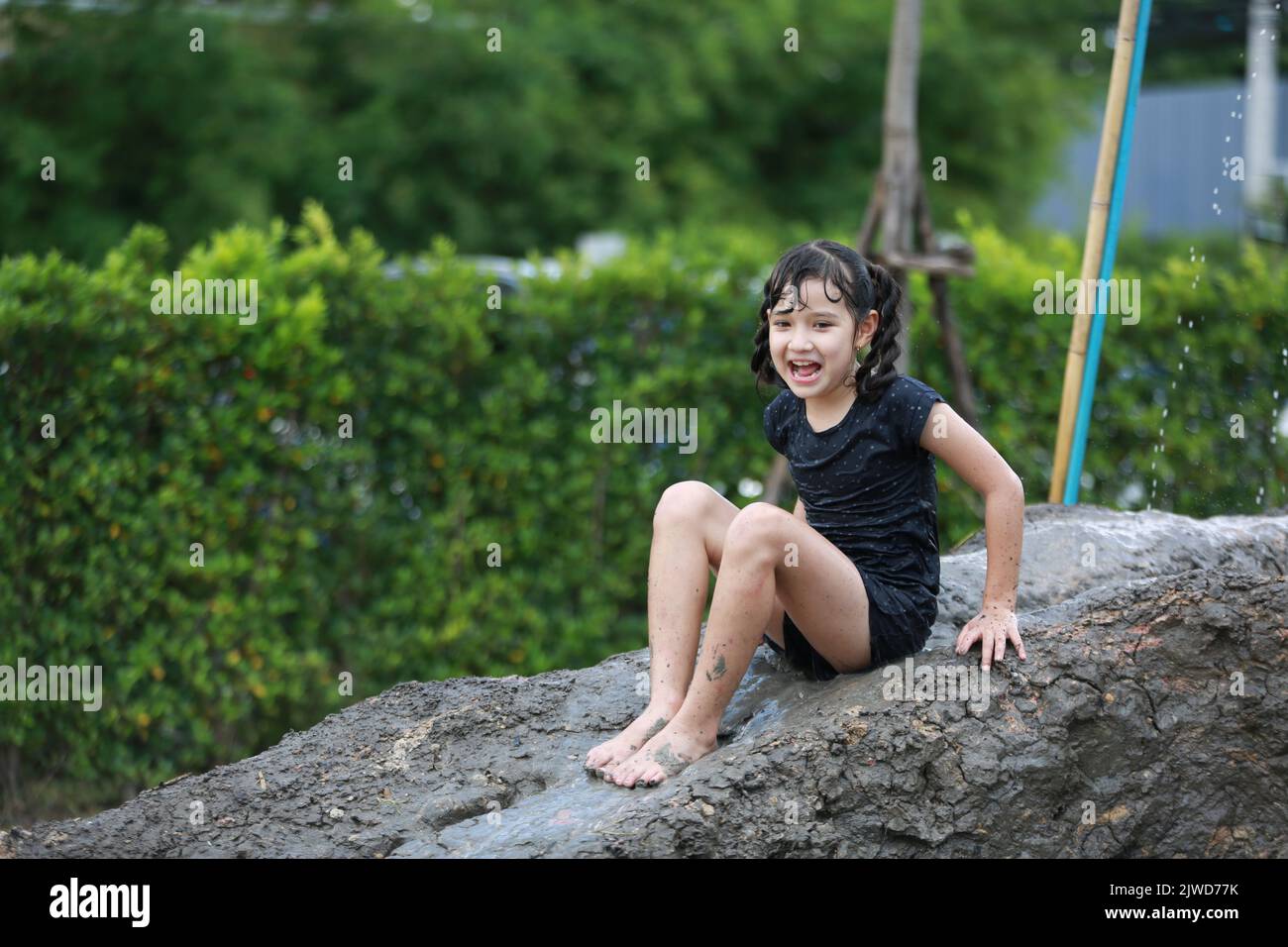 Group of kids playing on muck in the raining day Stock Photo - Alamy
