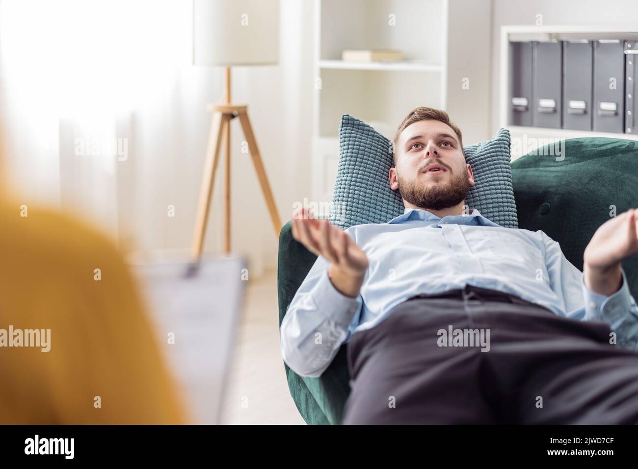 Patient man on sofa Stock Photo - Alamy