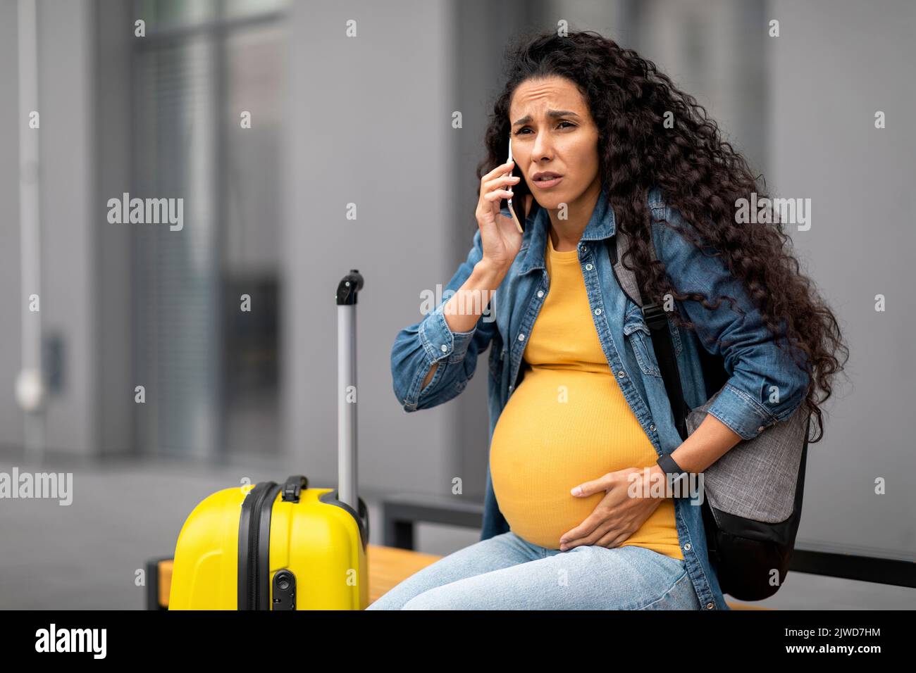 Worried expecting woman travelling alone, having phone call Stock Photo ...