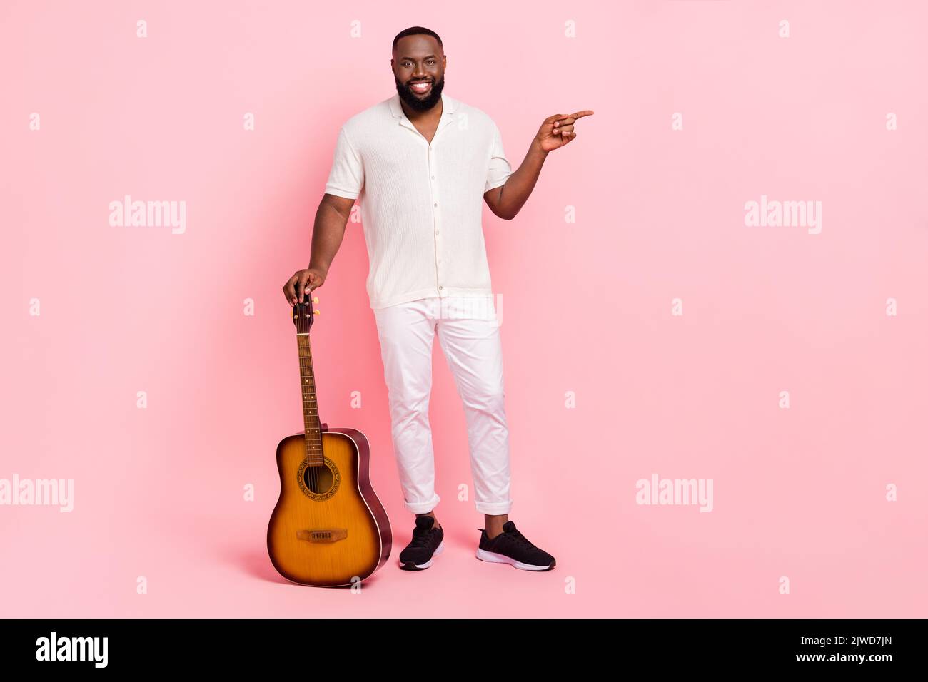 Photo of confident charming guy dressed white shirt holding guitar ...