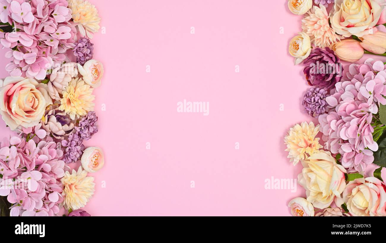 Romantic spring flowers on left and right side of pastel pink ...