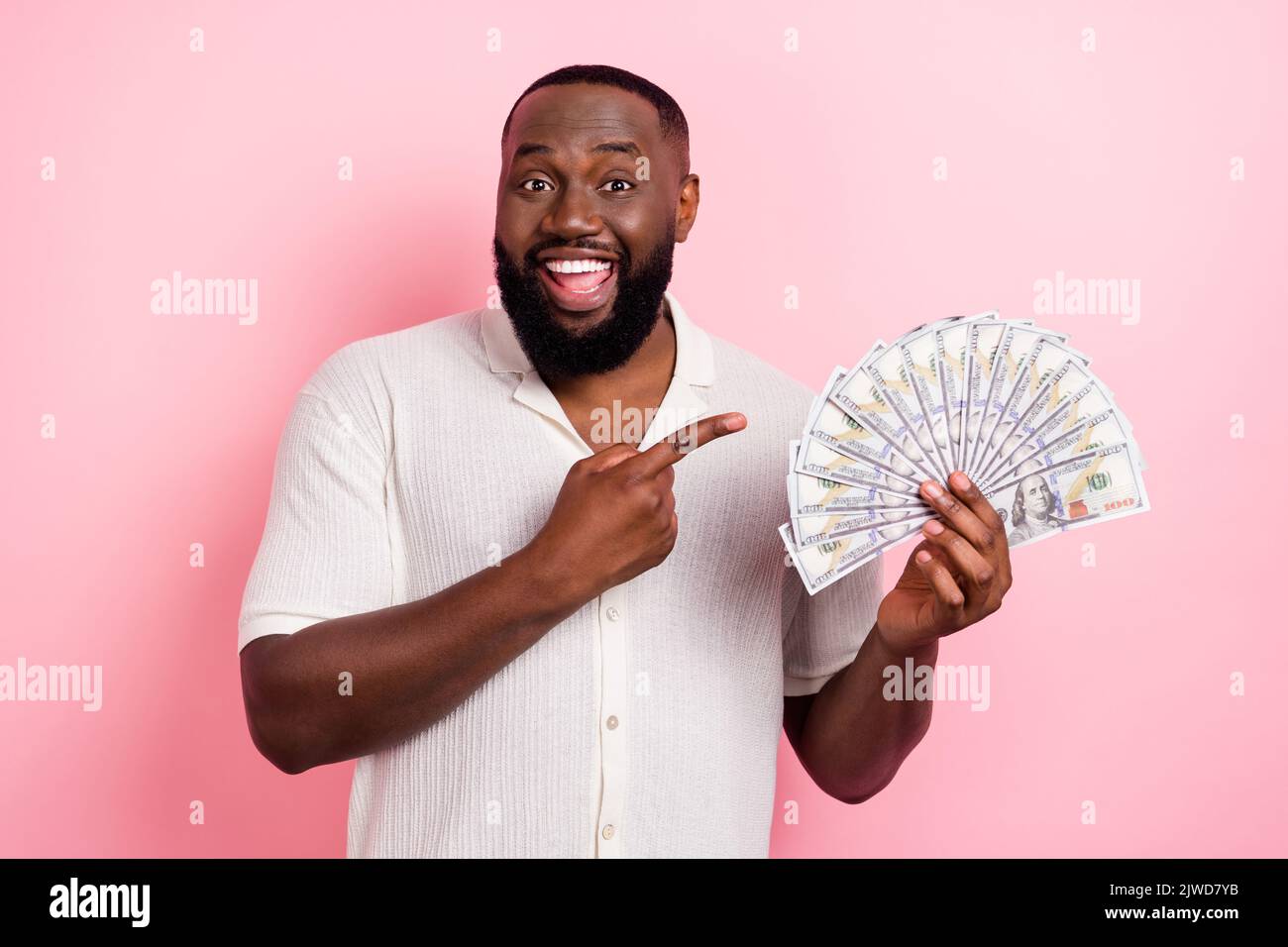 Photo of impressed pretty young man wear white shirt pointing finger ...