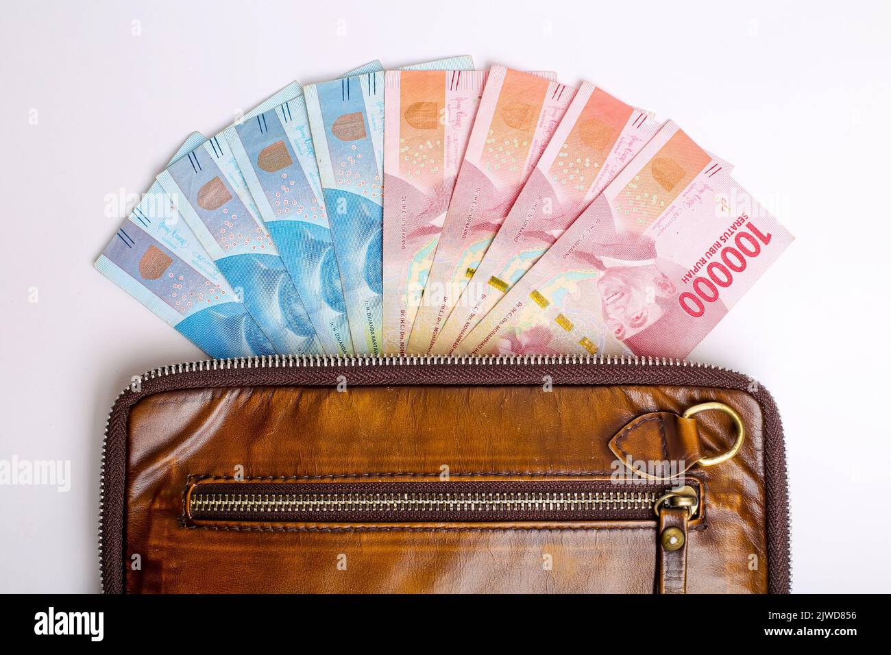 Indonesian rupiah money in brown wallet isolated on white background ...