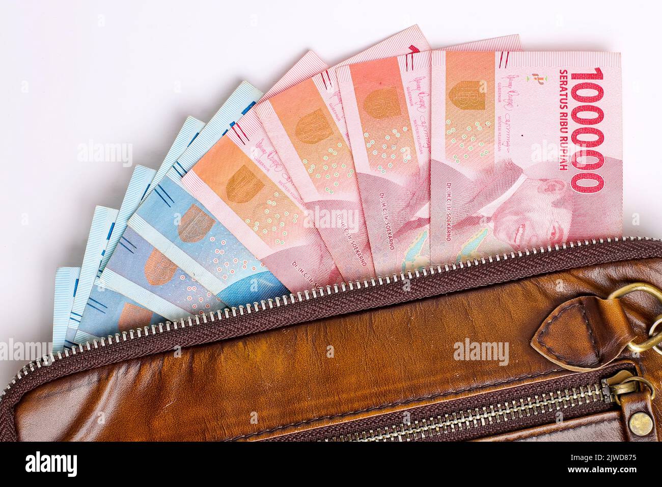 Indonesian rupiah money in brown wallet isolated on white background ...