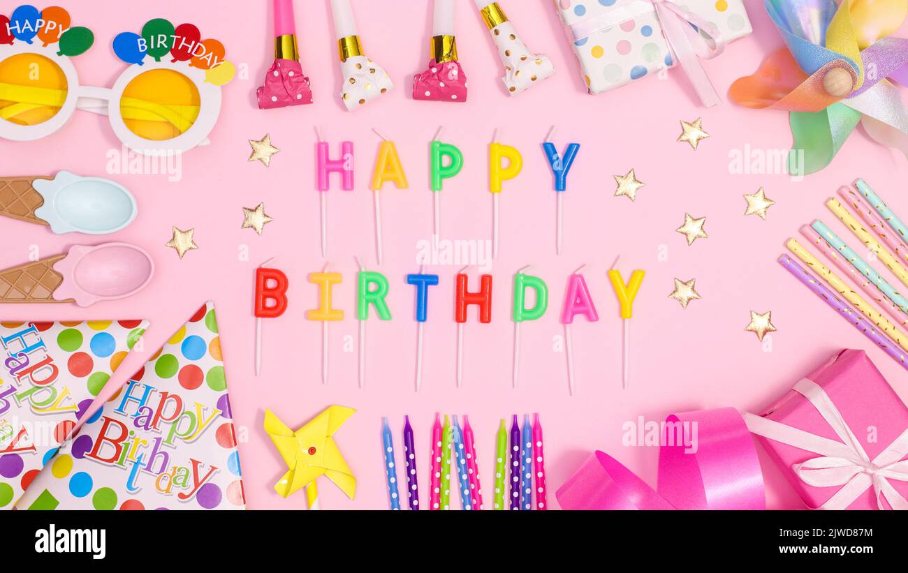 Happy birthday party background with party accessories on pastel pink ...