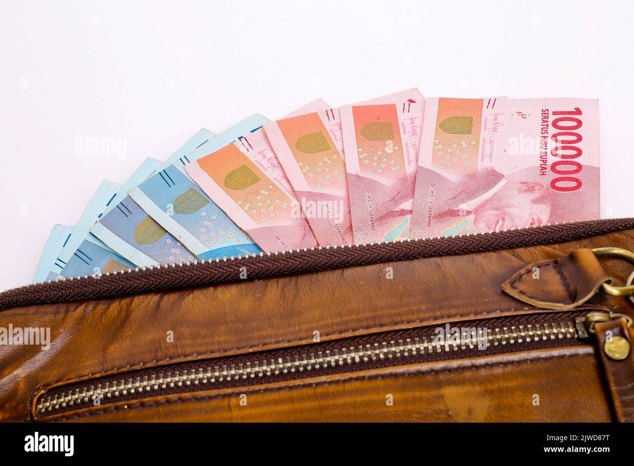 Indonesian rupiah money in brown wallet isolated on white background ...