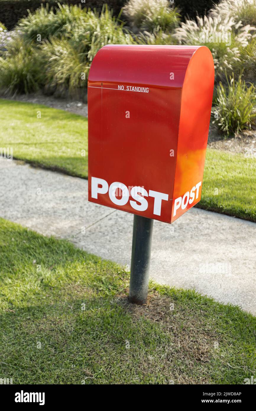 A red australia post letter box stripped of all branding and logos ...