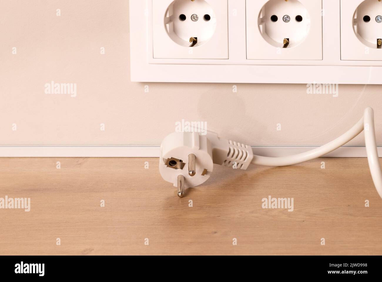Power cord cable unplugged with group of white european electrical ...