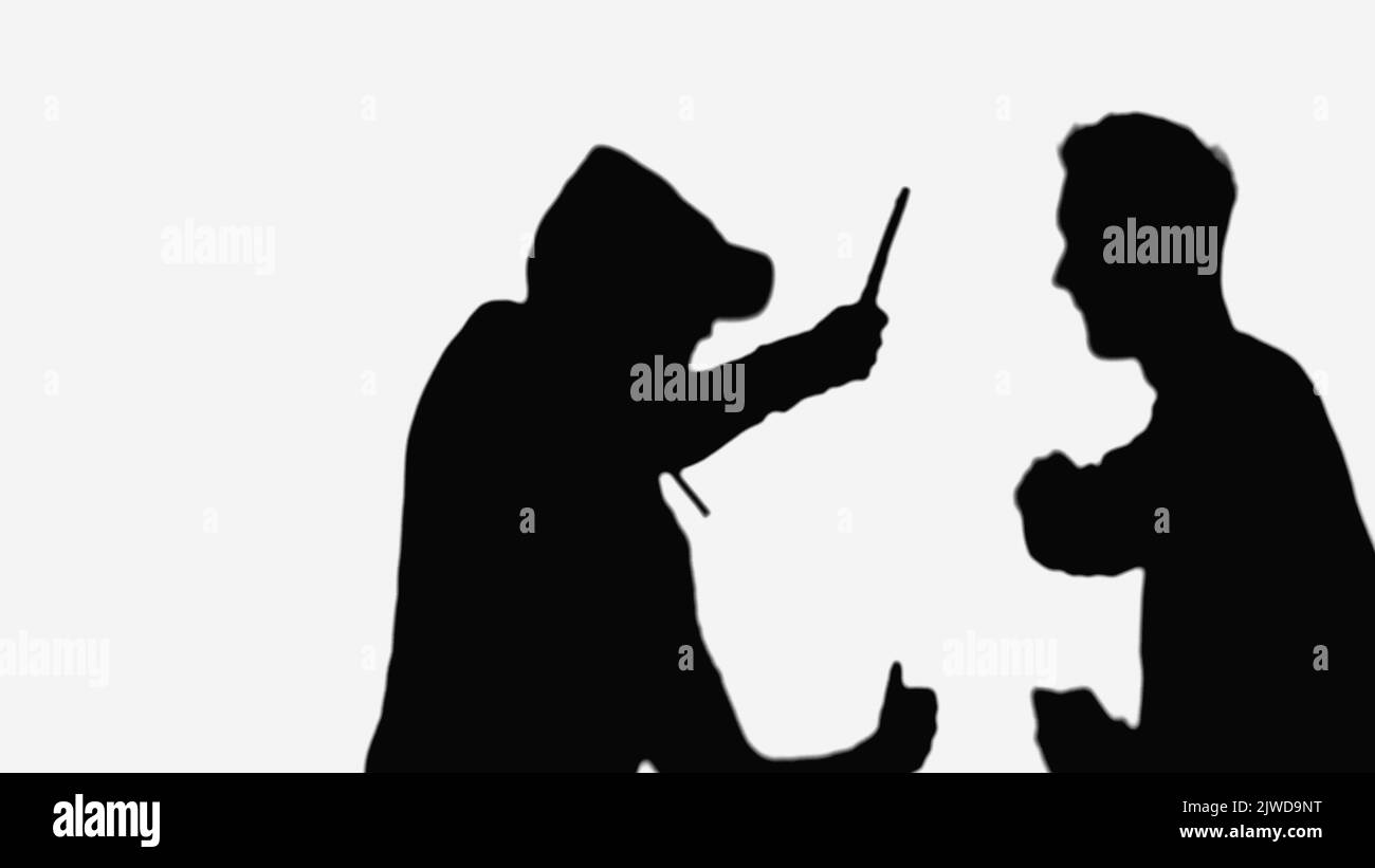 black silhouettes of robber with knife and man with clenched fists ...