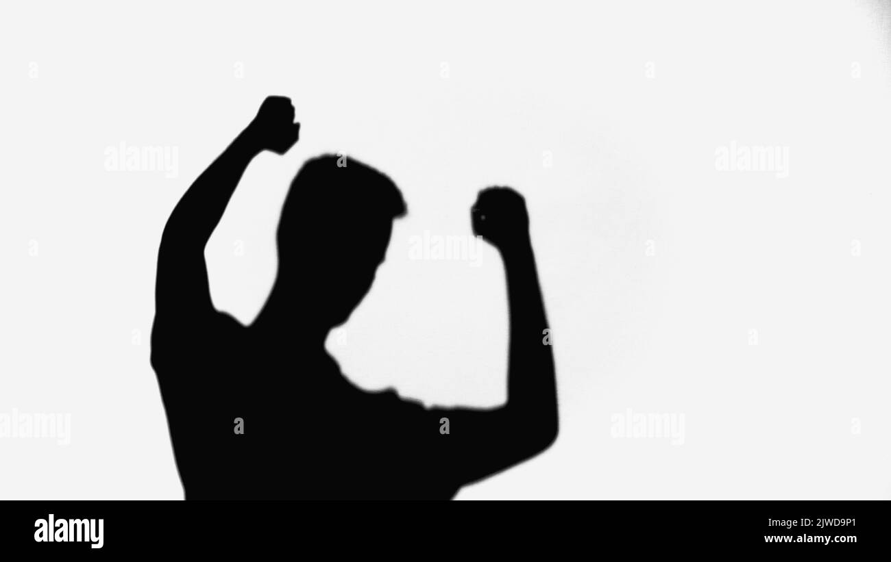 black shadow of man showing triumph gesture isolated on white Stock ...
