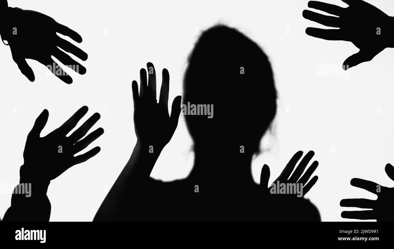 shadows of hands of people near bullied woman gesturing isolated on ...