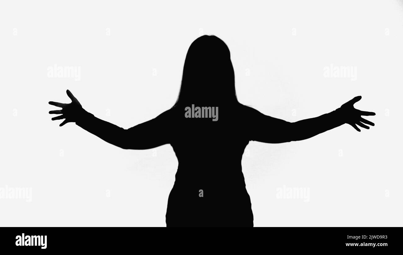 black silhouette of woman standing with open arms isolated on white ...