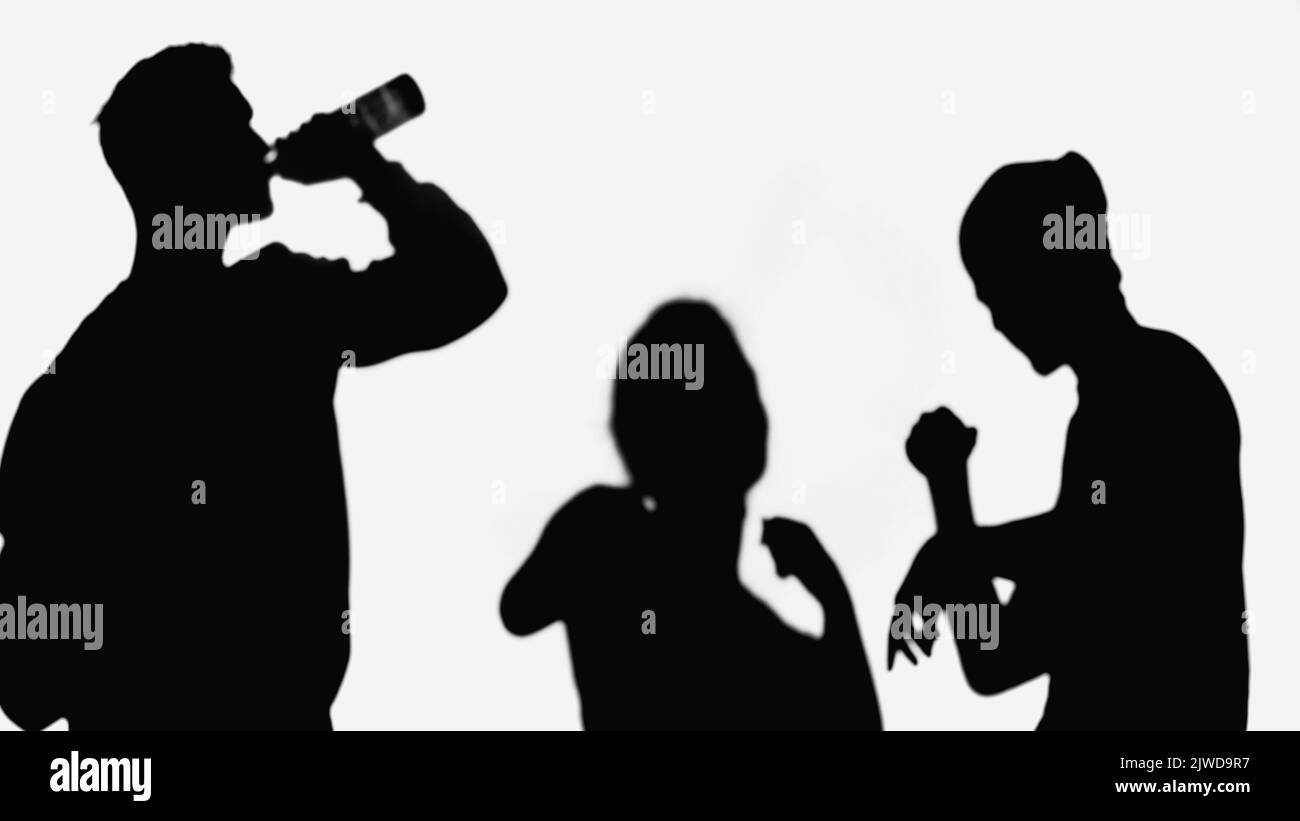 silhouette of man drinking beer near dancing friends isolated on white ...
