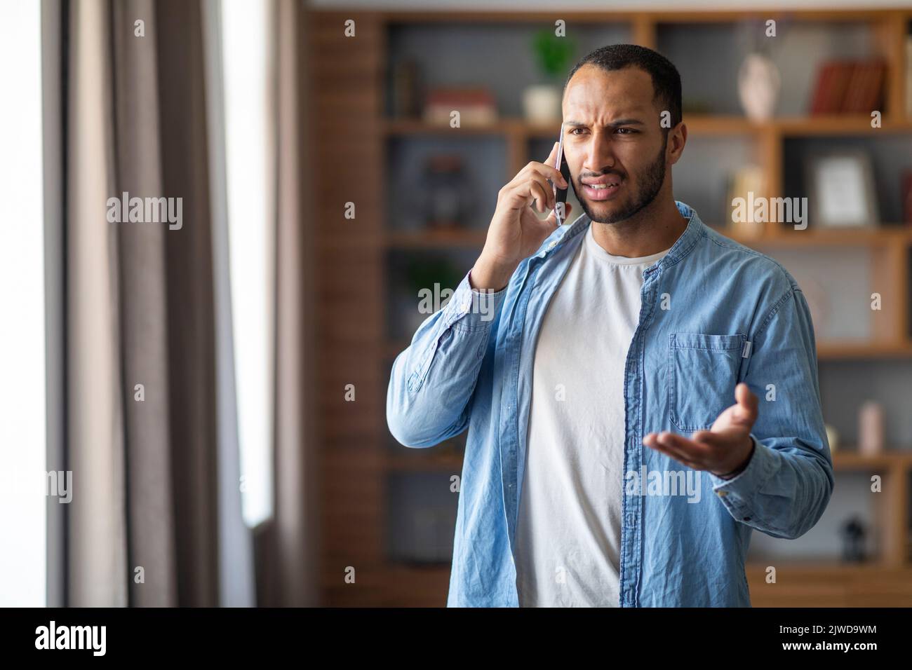 Confused man in room hi-res stock photography and images - Alamy
