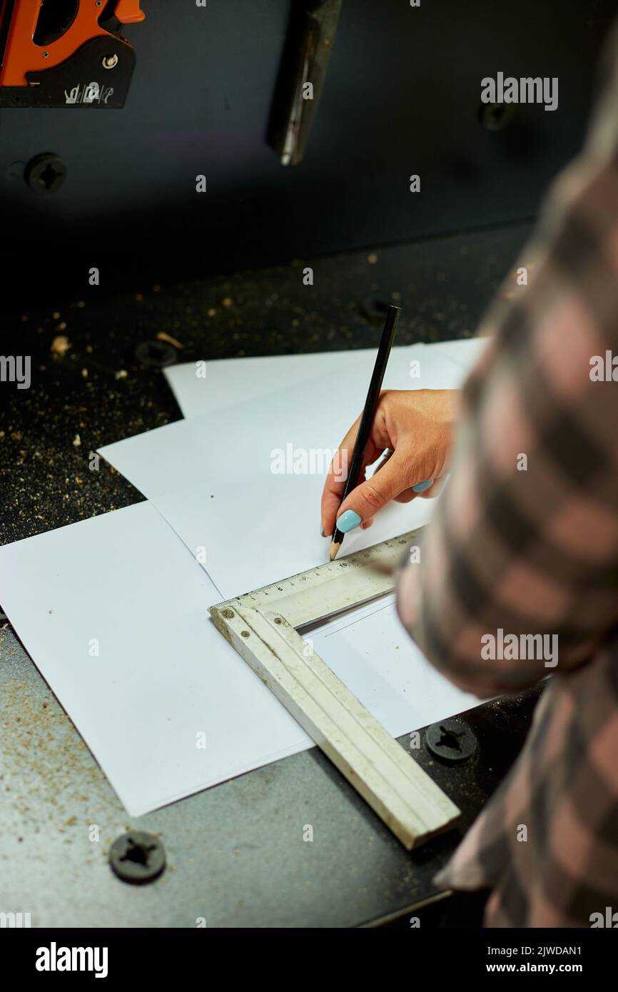 Female interior designer working on drawings, woman architect draws ...