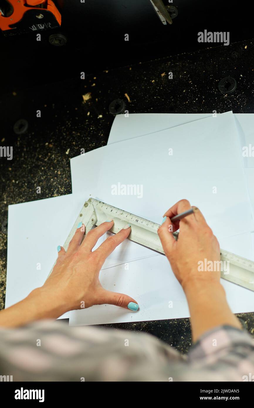 Female interior designer working on drawings, woman architect draws ...