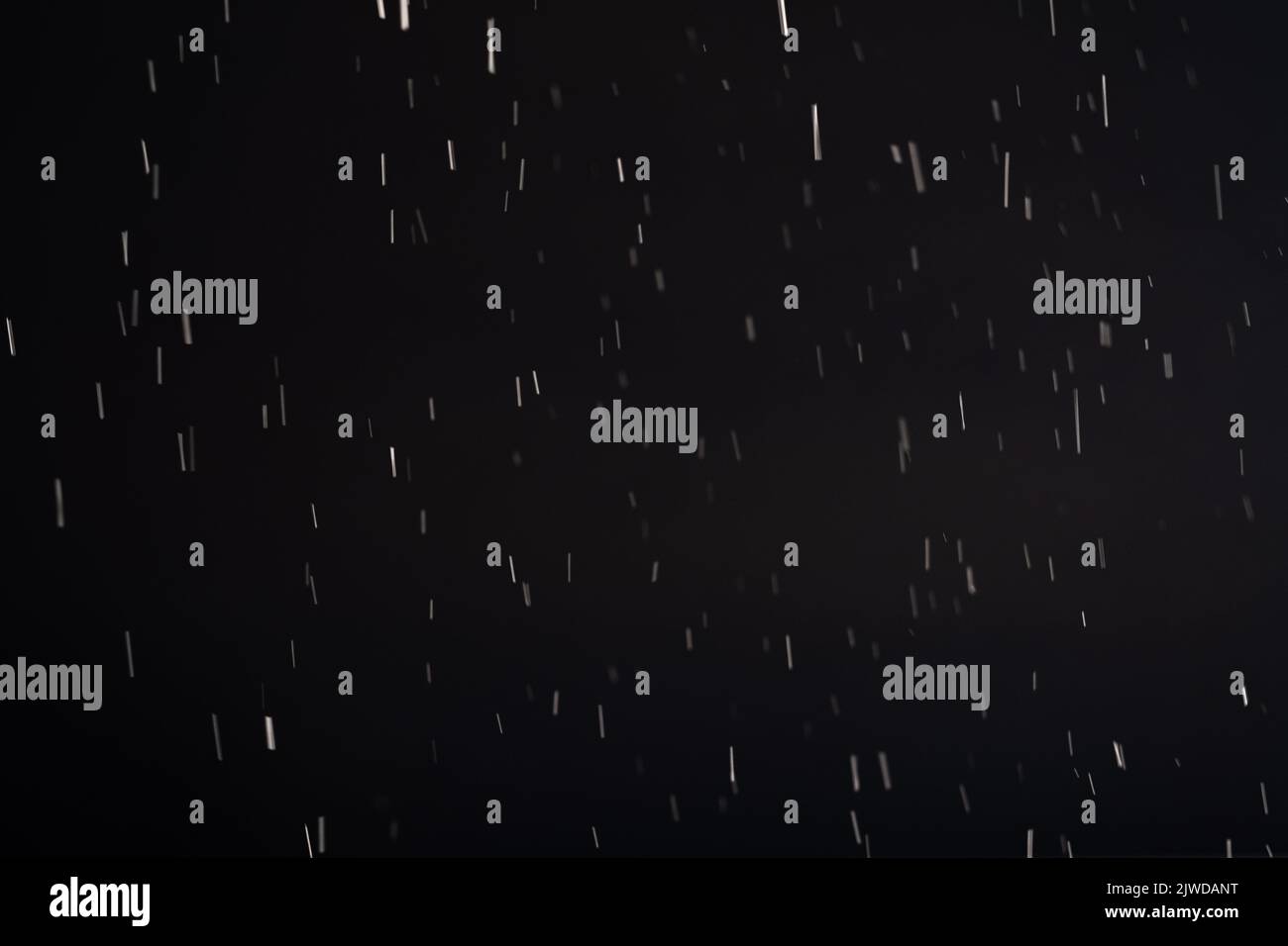 snowfall background blur flying white dust black Stock Photo - Alamy