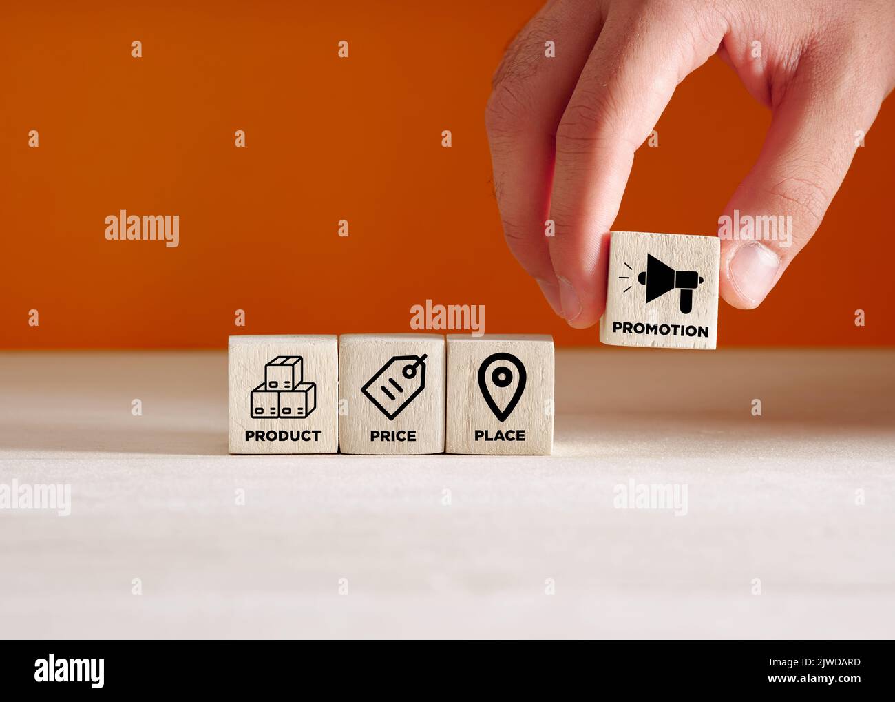 Hand puts the wooden cubes with the 4p marketing mix product, price ...