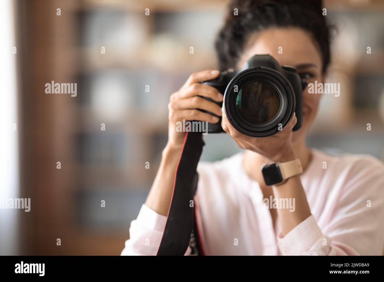 Pretty woman is professional photographer with dslr camera, copy space ...