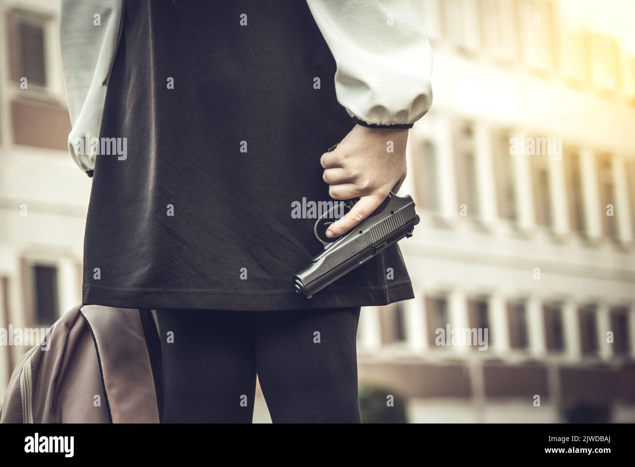 Firearms at school. A teenager with a gun on the background of the ...
