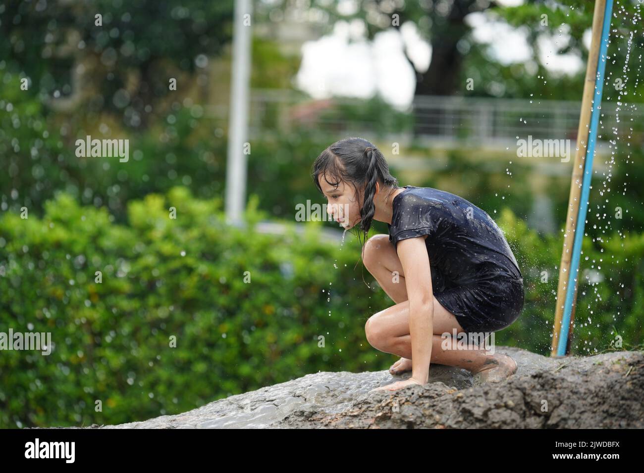 Group of kids playing on muck in the raining day Stock Photo - Alamy